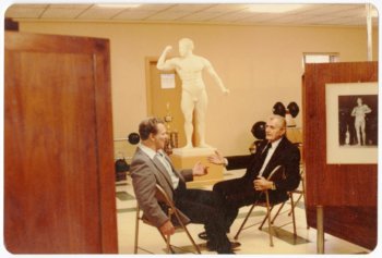 Two men talking beside cast of Sandow | Rogue Fitness