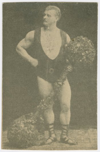 Sandow posing with large barbell | Rogue Fitness