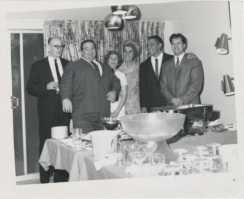 Paul Anderson with Peary Rader, Bill Pearl, and other party attendees ...