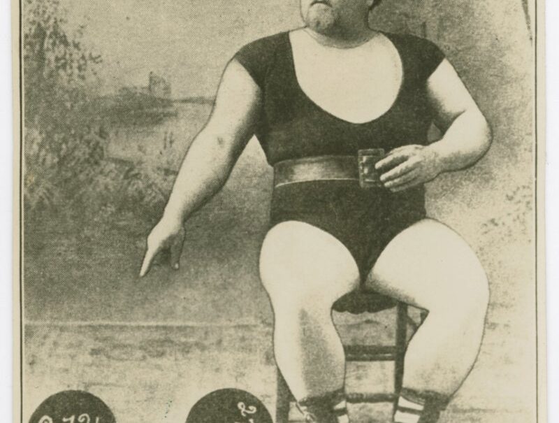 Louis Cyr seated portrait with dumbell | Rogue Fitness